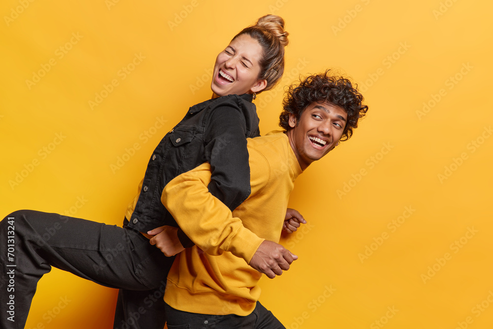 Positive female and male friends foolishing around gve piggyback ride ...