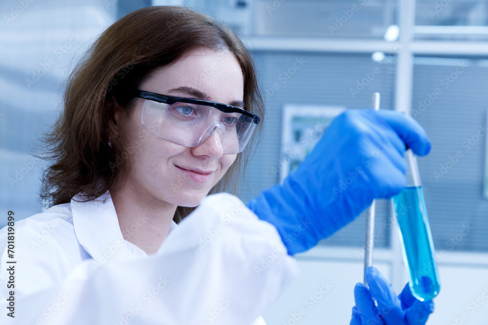 Photo Stock Young woman scientist conducting research investigations in ...