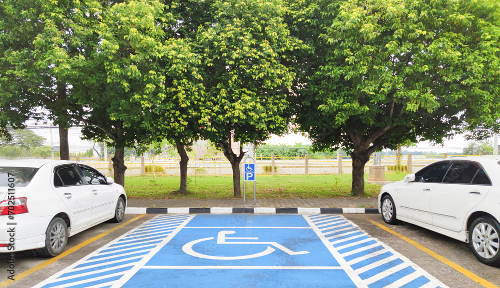 Car parking near handicap parking sign symbol at asphalt parking lot ...