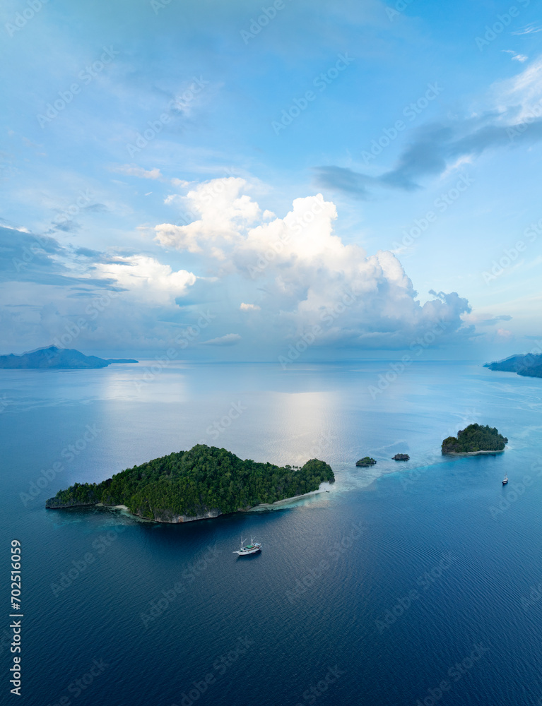 Dawn illuminates scenic limestone islands fringed by beautiful coral ...