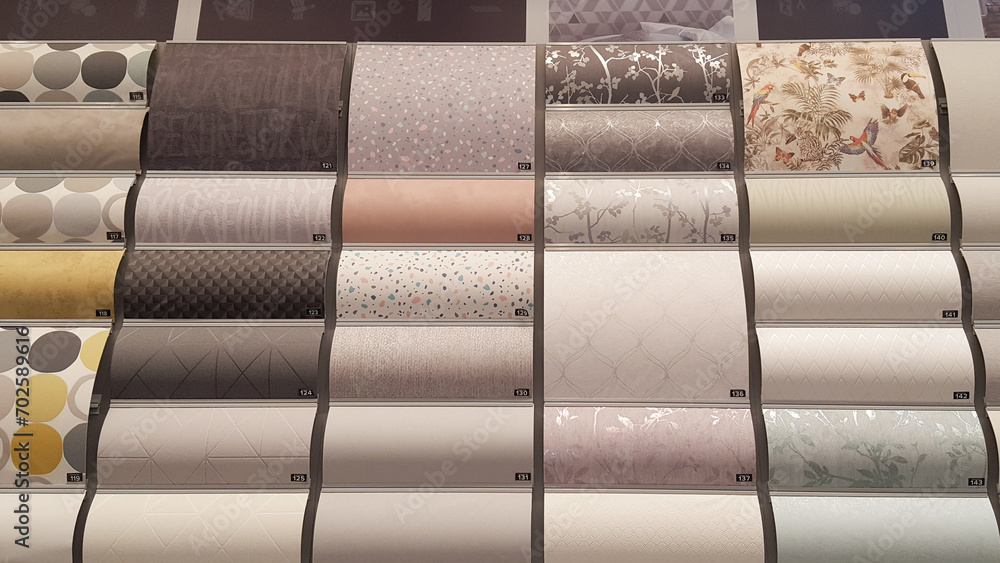Samples of different wallpapers on store racks for home renovate and ...