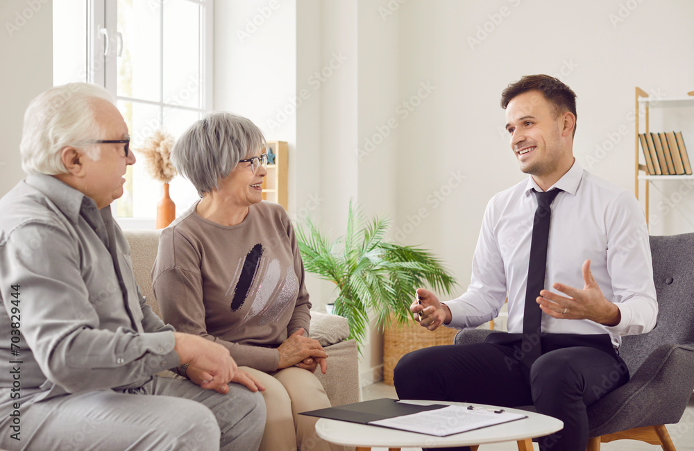 Senior pair and young consultant talking, giving expert advice, help ...