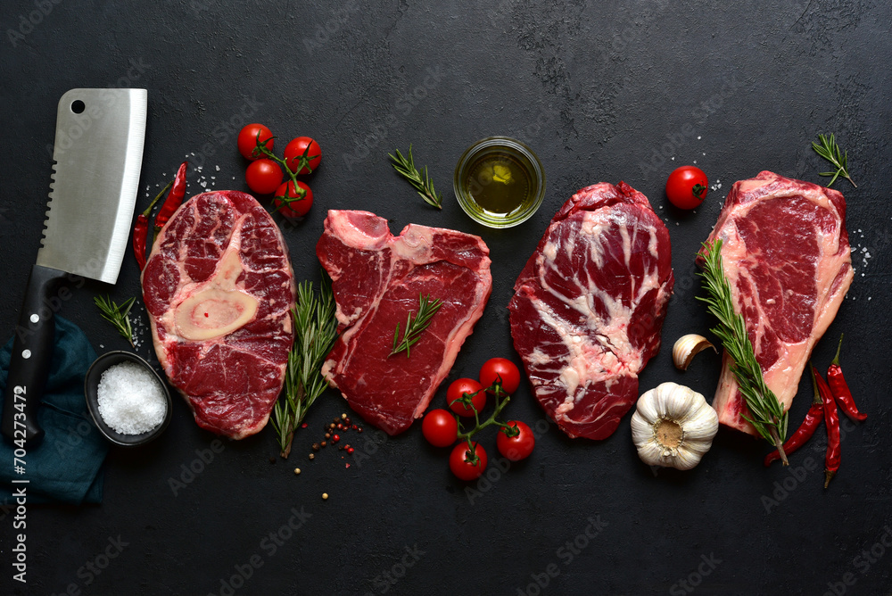 Different types of raw marbled beef steaks : T-bone, ossobuko, spider ...