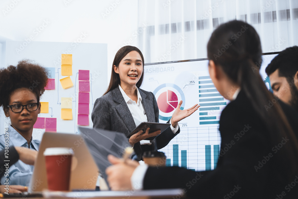 Young asian businesswoman presenting data analysis dashboard on TV ...