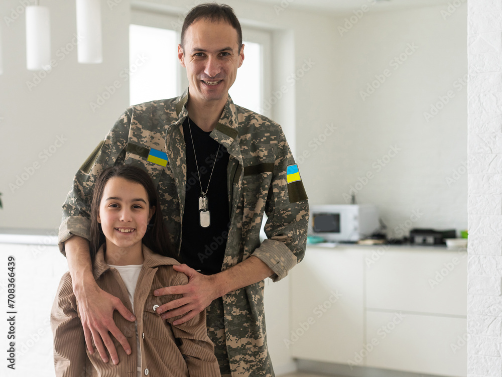 Father in Ukrainian military uniform and his daughter. Family reunion ...