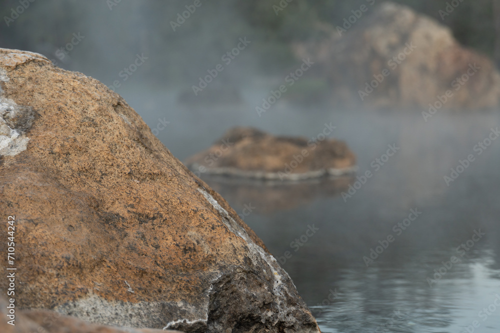 Rocks protruding above the surface of the water in chaeson Hot Spring ...