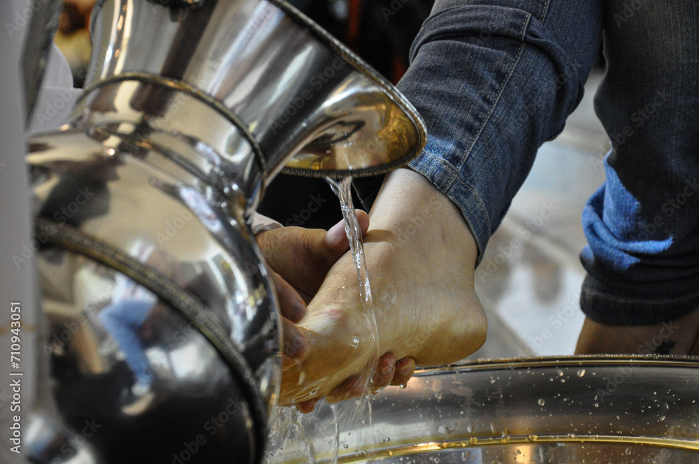 In the foot-washing ceremony, on Maundy Thursday, the Priest washes a ...