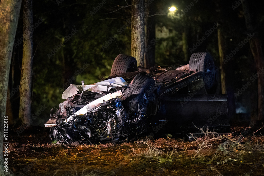 Wrecked car upside down after accident at night Stock Photo | Adobe Stock