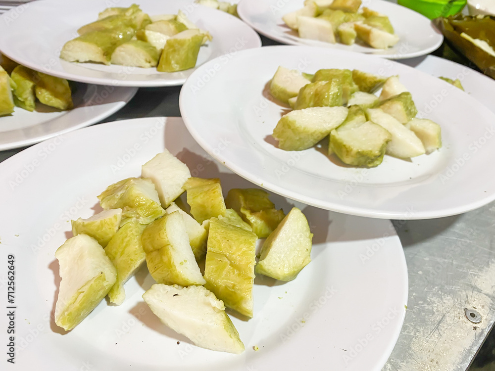 Lontong. Photo of sliced rice cake on white plate. Traditional Javanese ...