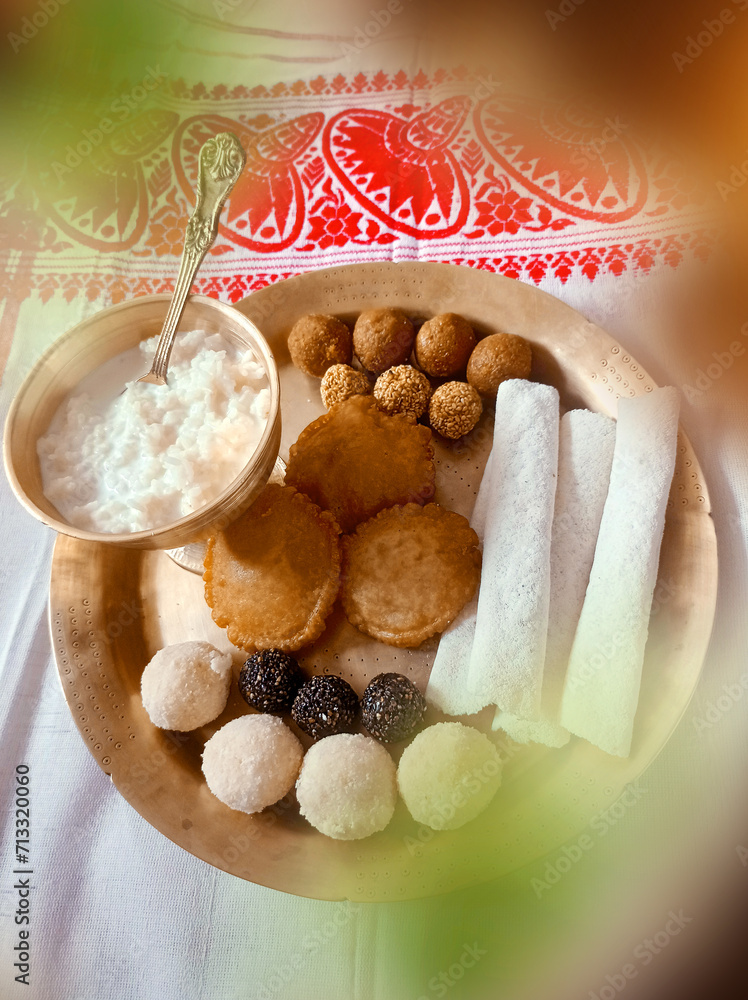 Assamese traditional food items like pitha, laddu, doi sira with ...
