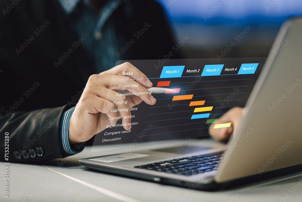 Project manager working and update tasks with milestones progress ...