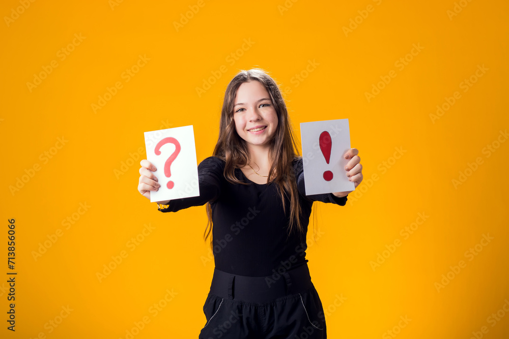 A portrain of kid girl holding cards with question mark and exclamation ...