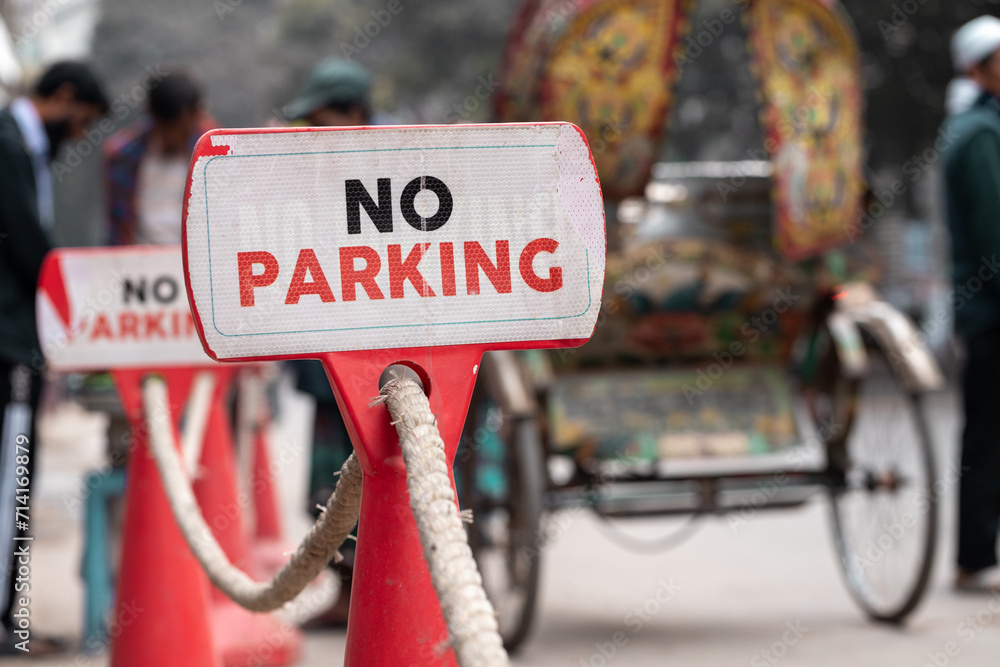 No parking red sign. A rickshaw puller parked his rickshaw beside no ...