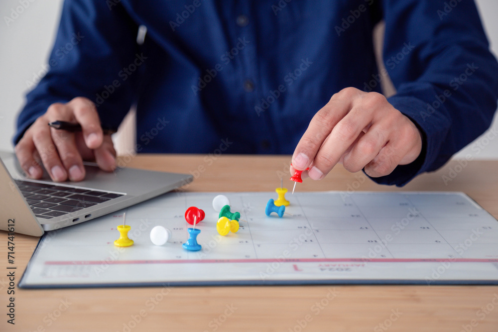 Businessman manages time for effective work. Calendar on table ...