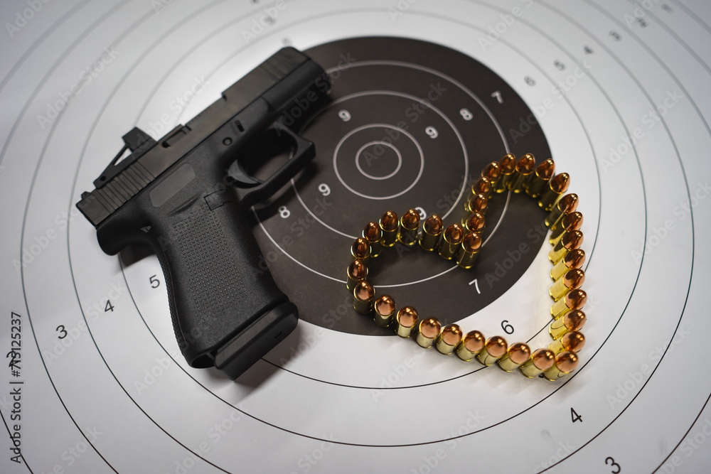 Theme of Valentine's day and weapons. A modern compact pistol with a ...
