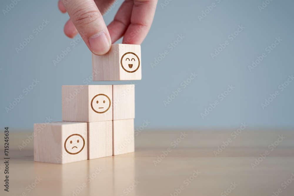 Hand select happy smiling face from stack. Feedback rating and positive ...