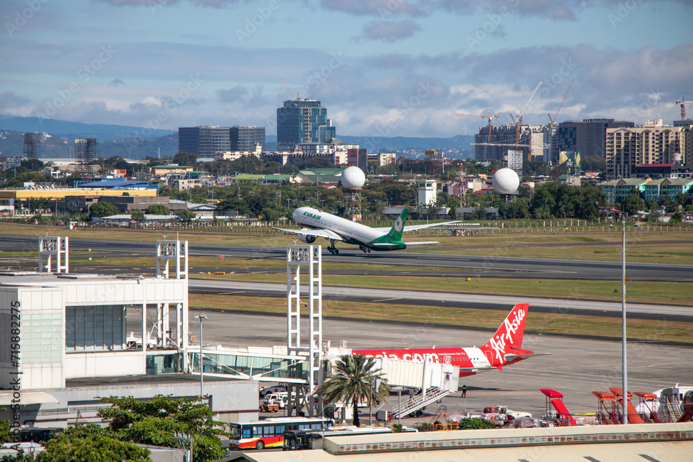 Aerial view of EVA Air Boeing 777-300ER taking off on runway near ...