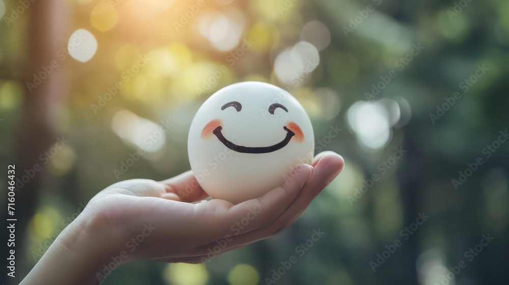 Self made hand draw, yellow ball with happy smiley face. Hand holding ...