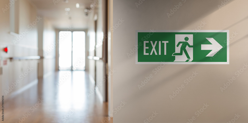 Emergency fire exit sign in the corridor of the school. Arrow on the ...