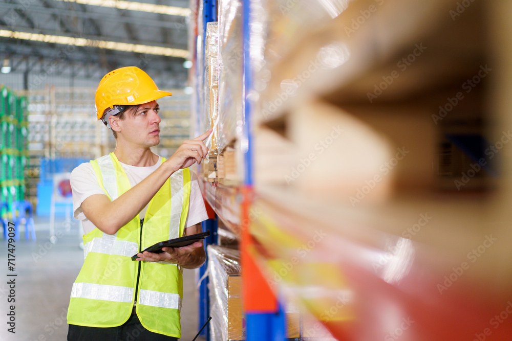 Caucasian male warehouse officer is currently conducting a stock ...