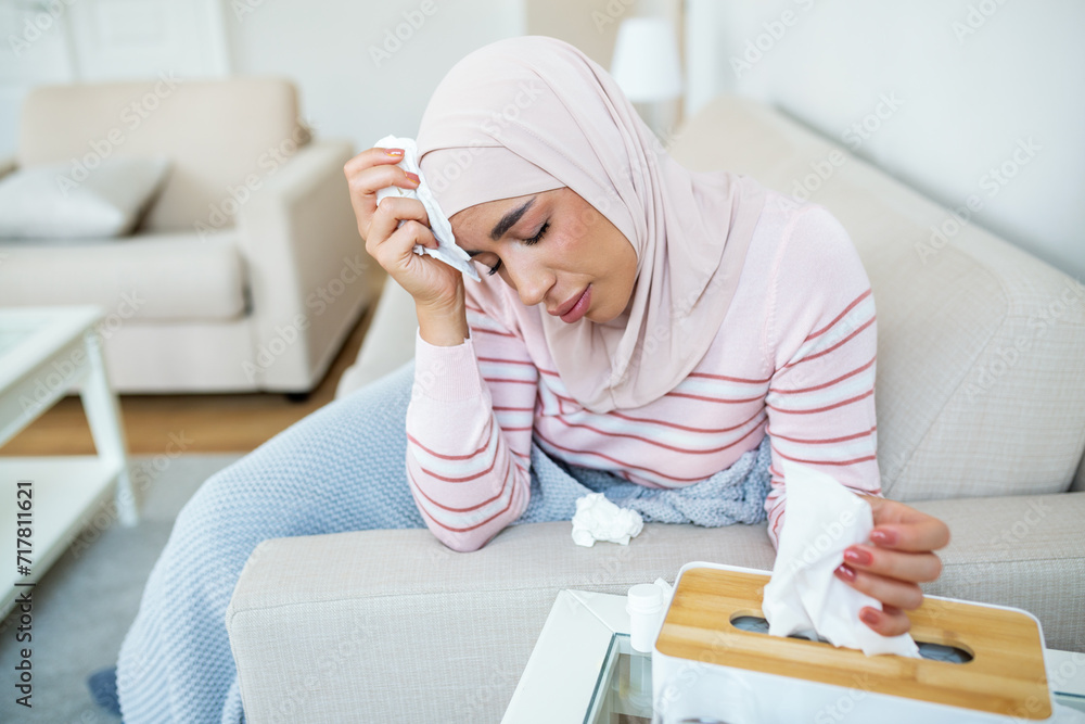 Sick day at home. Young Arabic woman has runny and common cold. Cough ...
