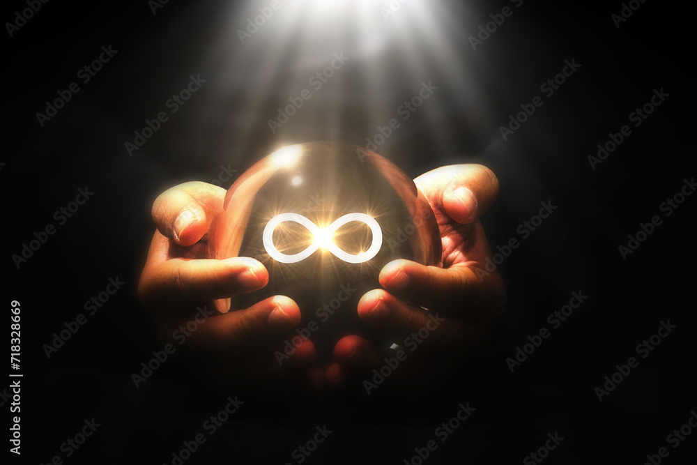 Fotografie Infinity Symbol Glowing in Crystal Ball : Mysterious hands ...