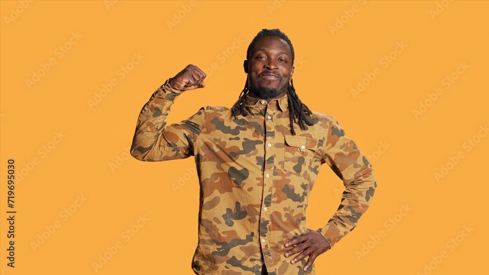 Photo Stock Athletic person flexing his arms muscles in studio and ...