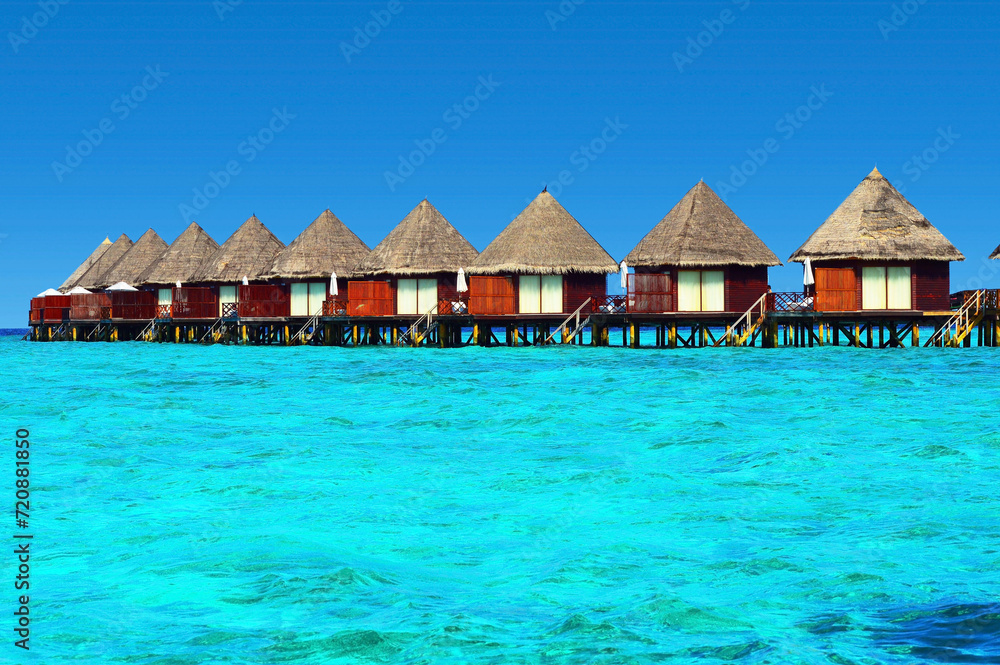 Water villas stand abreast in Maldivian sea 1 Stock Photo | Adobe Stock