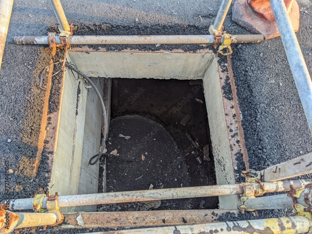 Man hole under ground trench with scaffolding hard barricade. The photo ...