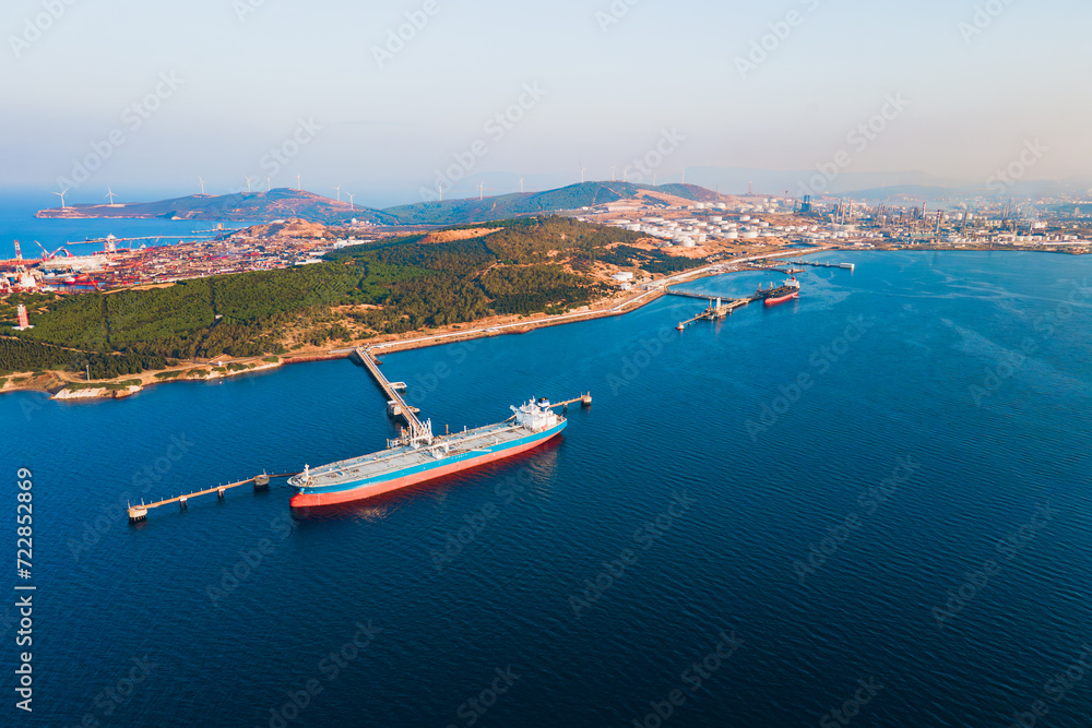 Crude oil tanker ship carrier unloading in petrochemical terminal ...