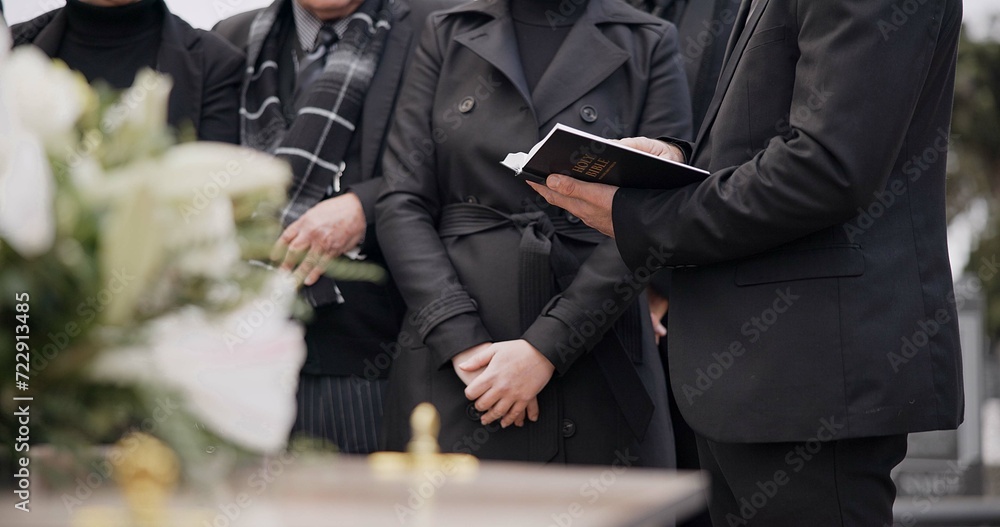 Bible, hands and family at funeral, cemetery or burial ceremony ...