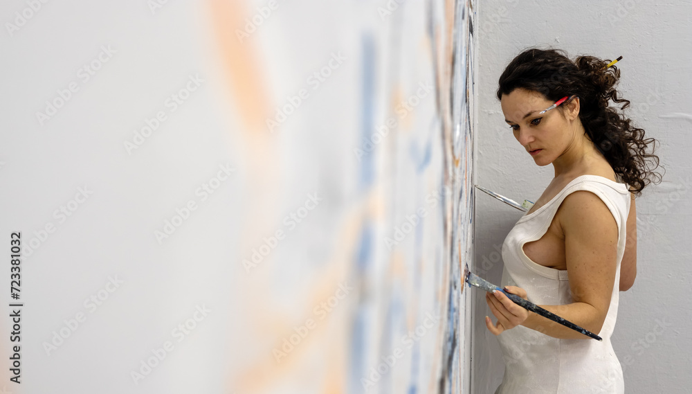 sexy beautiful pretty mature artist woman painter with curly brunette hair in white casual ...