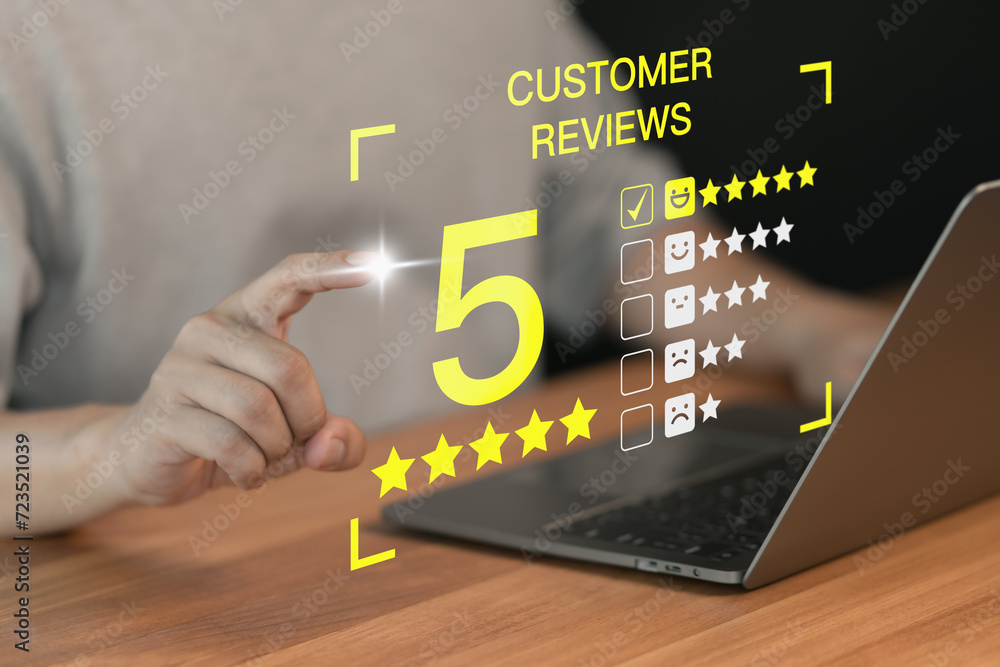 Customer hand using a laptop with pop up smiley face and five star icon ...