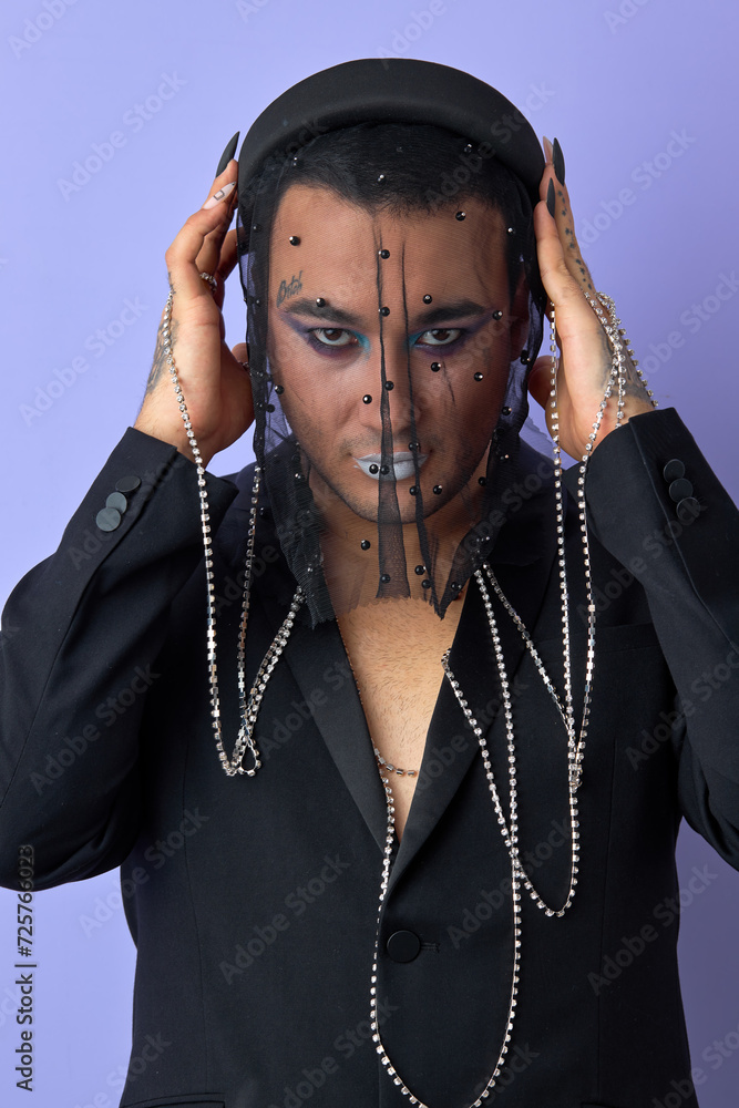 Handsome transgender male with translucent face cape posing at camera ...