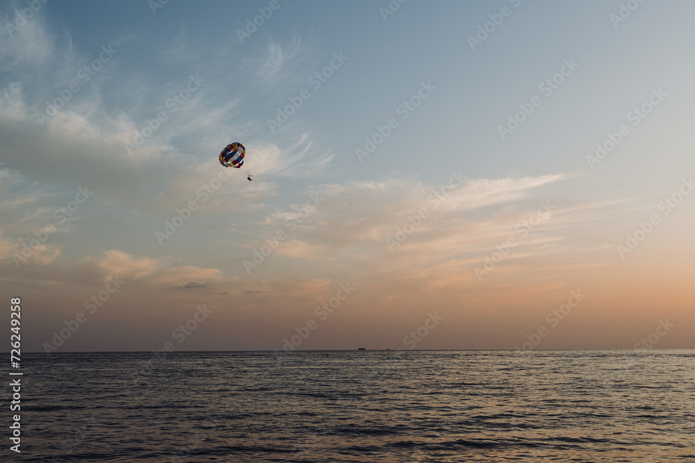 Parasailing.An active type of recreation at sea. A parachute floats in ...