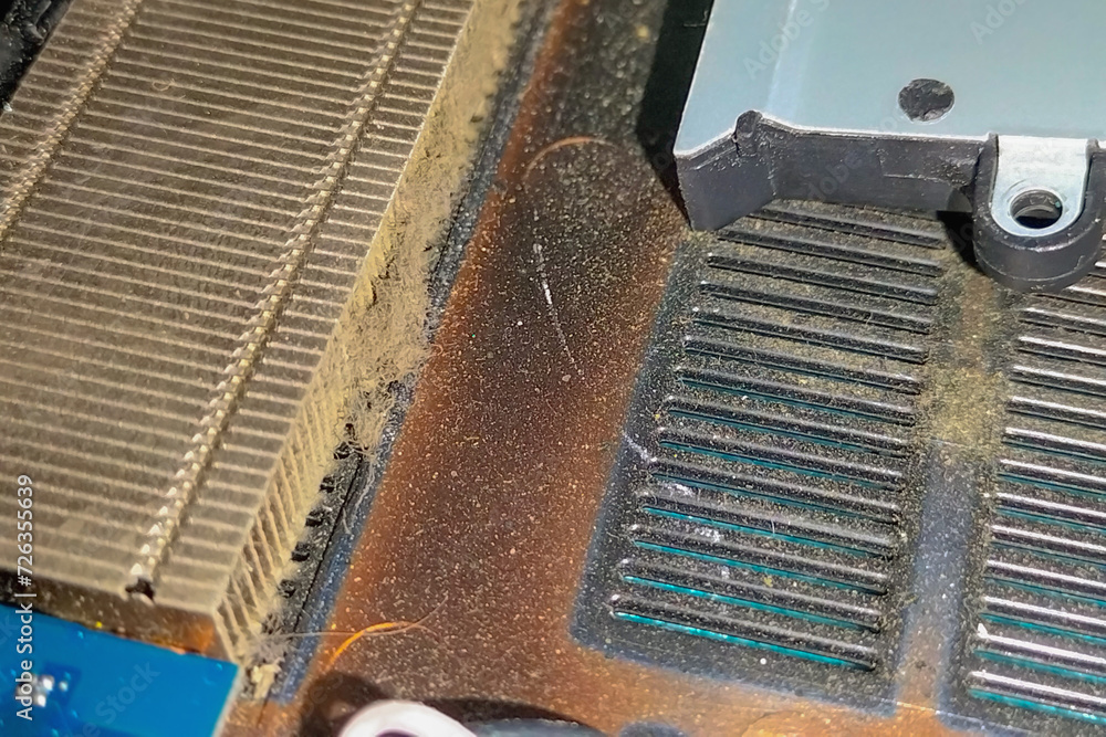 Laptop cooling heatsink clogged with lint and dust, which can lead to ...