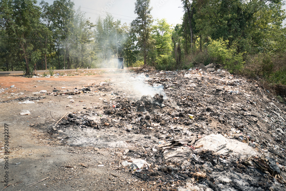 Garbage, fire burning and smoke in landfill. Also called trash, waste ...