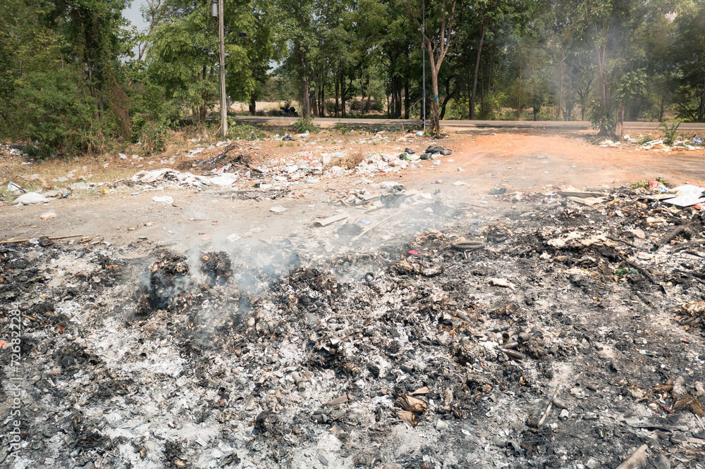 Garbage, fire burning and smoke in landfill. Also called trash, waste ...