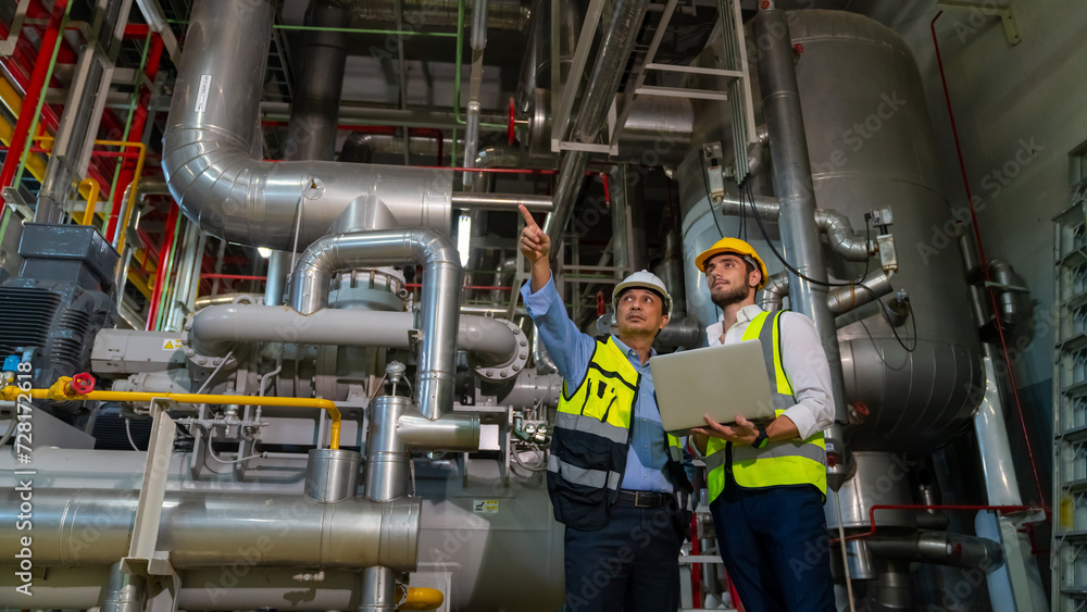 Professional male electrical engineer in safety uniform working and ...
