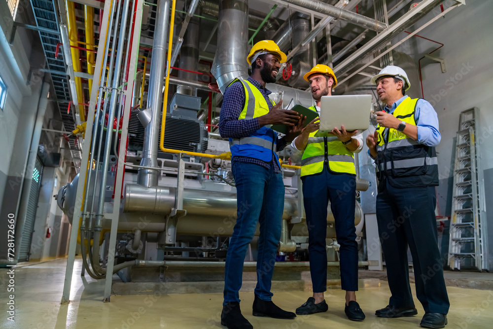 Group of Diversity electrical engineer in safety uniform working ...