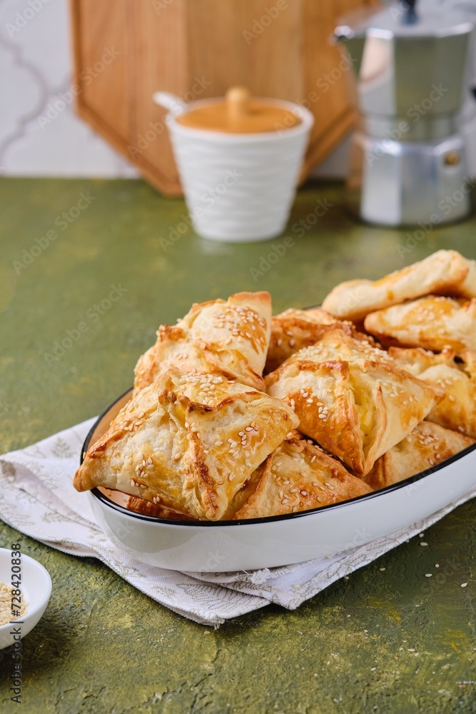 Unsweetened pastries, puff pastry envelopes with cheese filling in a ...