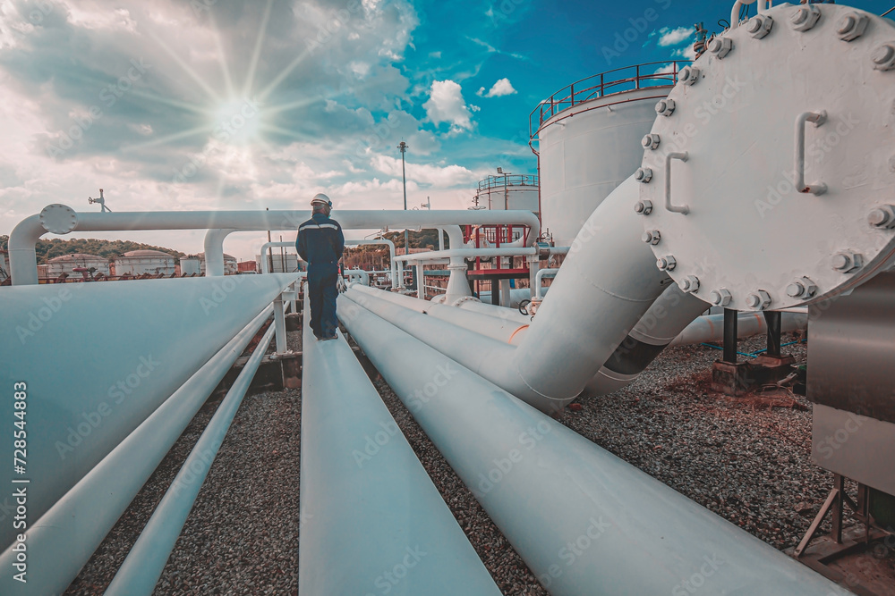 Male worker inspection at steel long pipes and pipe elbow in station ...