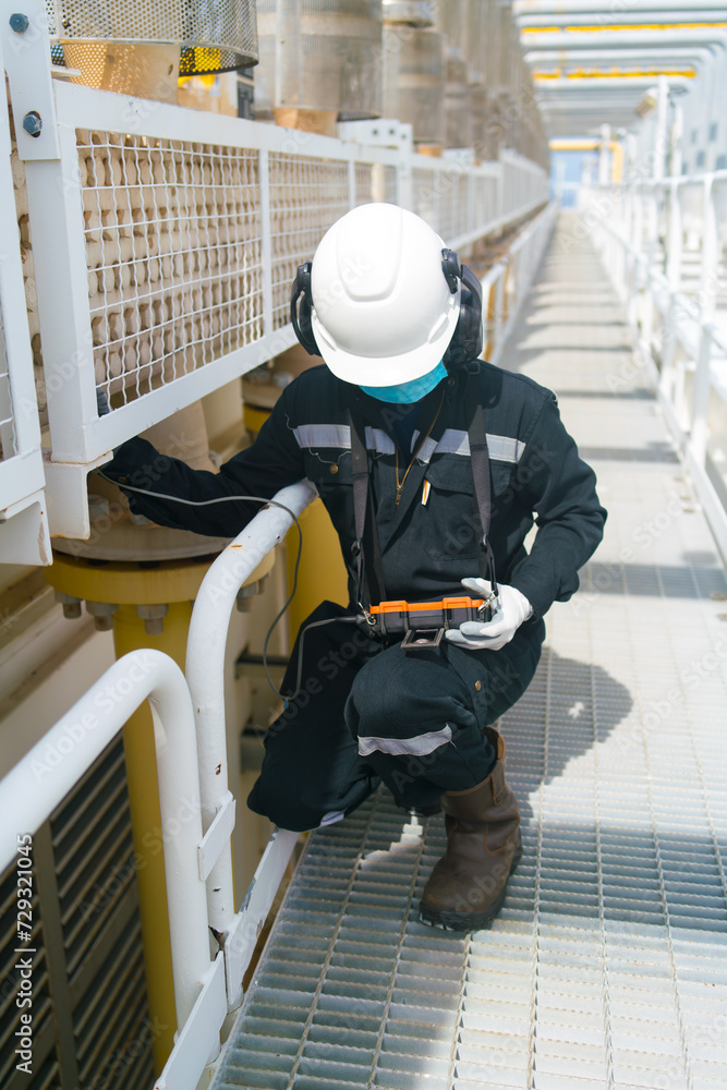 Non-destructive testing technicians are checking the thickness of pipes ...