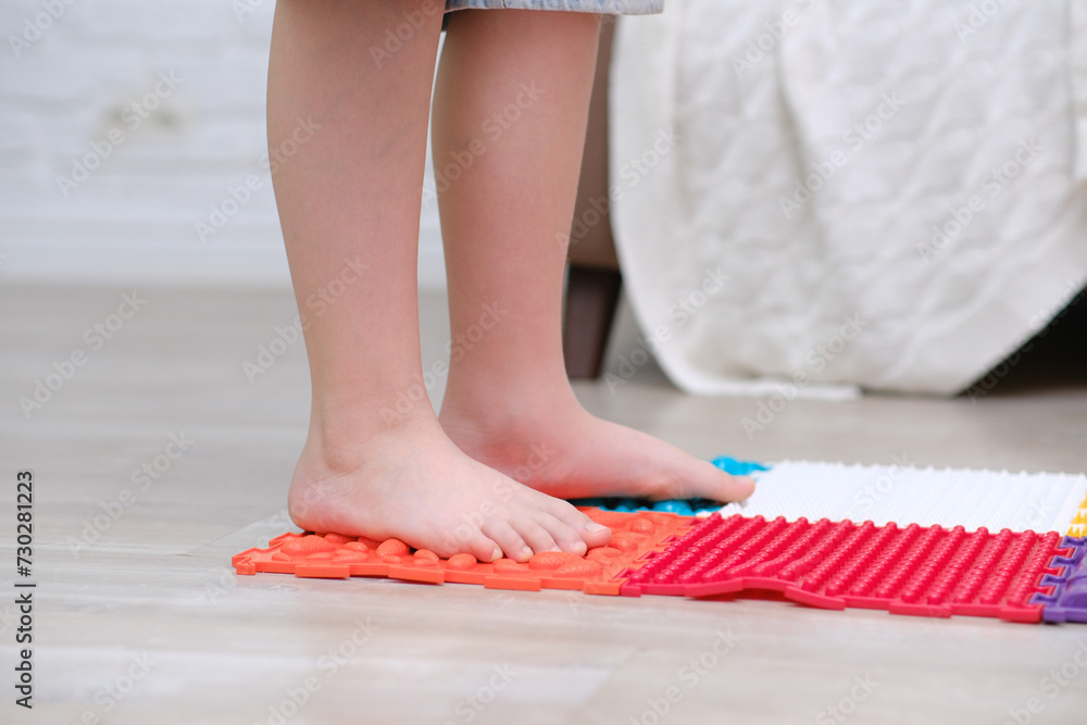 Children's bare feet, walking on an orthopedic massage mat. Prevention ...