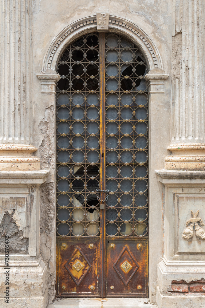 Arched Blue Wooden Door with a Rusted Iron Filigree Door in a Mausoleum ...