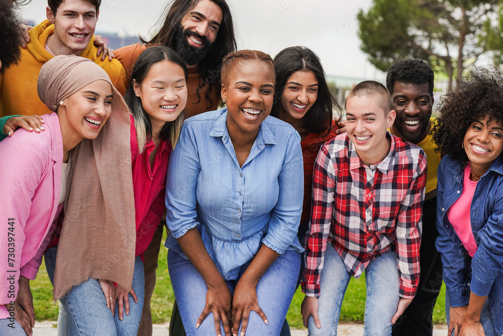 Crowd of happy multiracial people having fun in the city while taking a ...