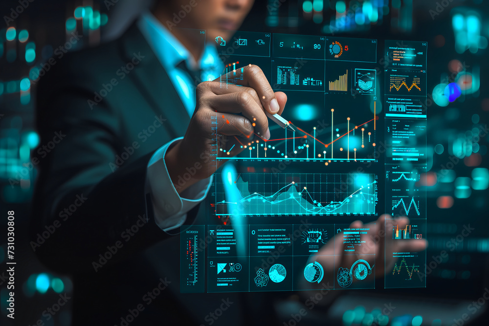 Businessman sketching a growing virtual hologram of statistics, graphs, and charts. Representing ...