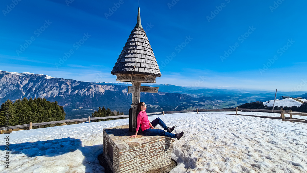 Hiker woman at wooden monument at Dreilaendereck, Karawanks, Carinthia ...
