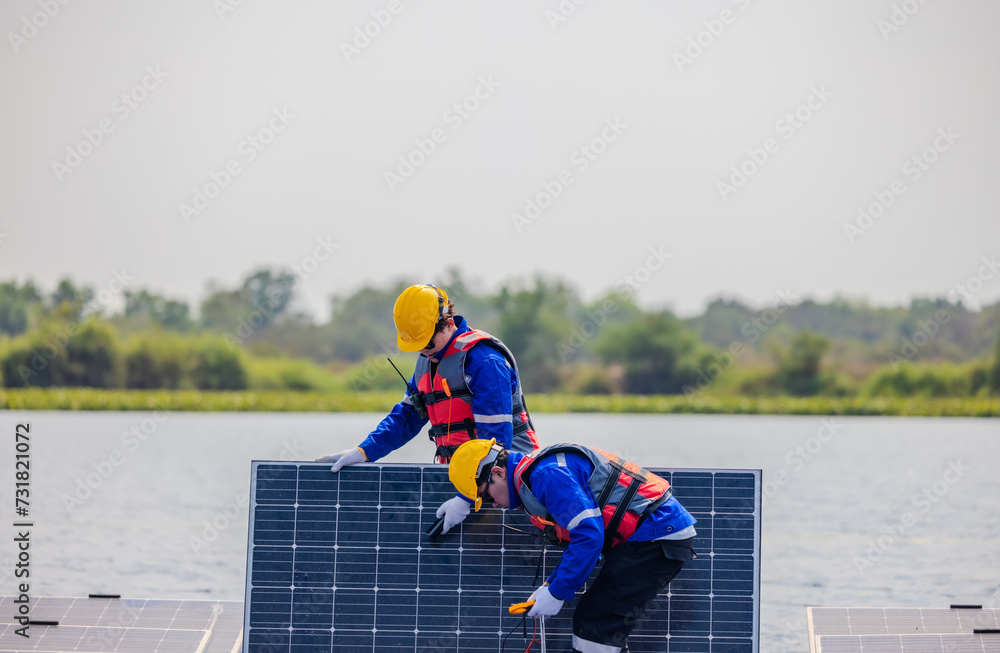 Technicians check floating solar farm wiring, polarity, and grounding ...