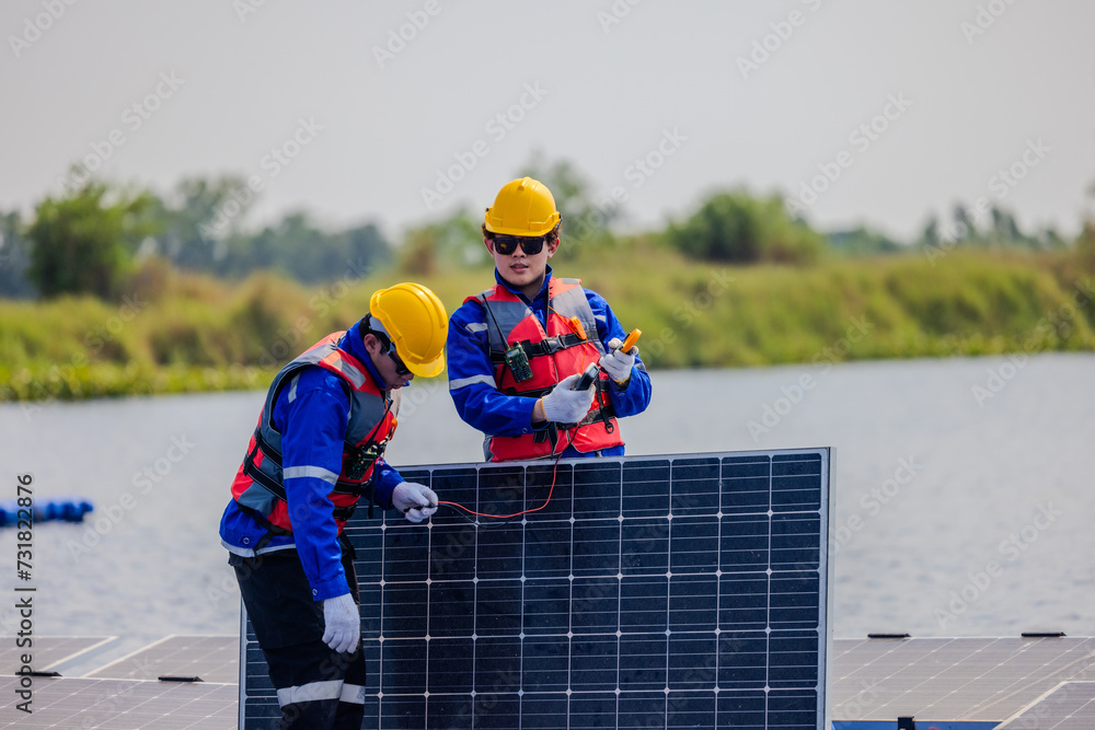 Technicians check floating solar farm wiring, polarity, and grounding ...